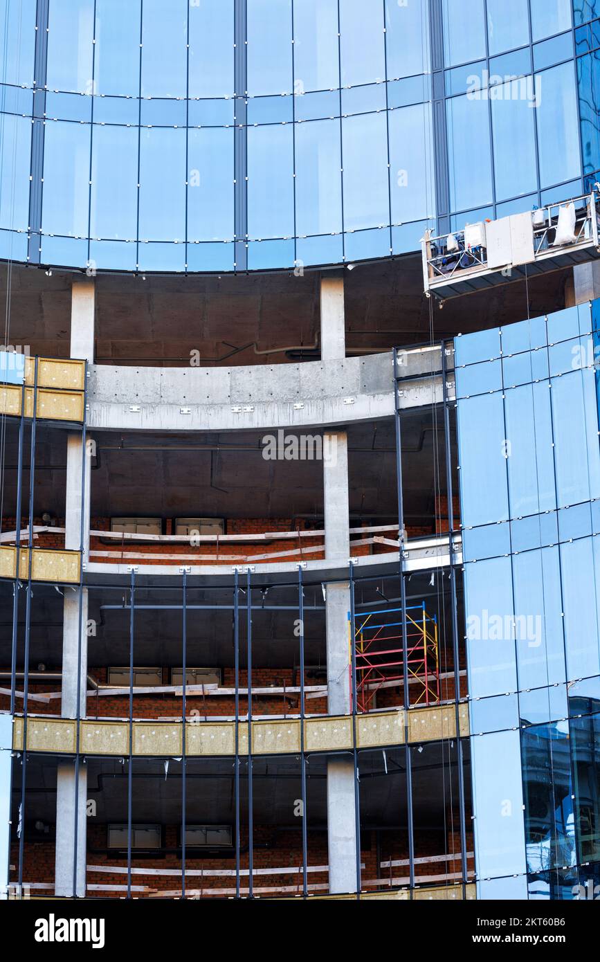 A fragment of the installation of a facade glazing system during the ...