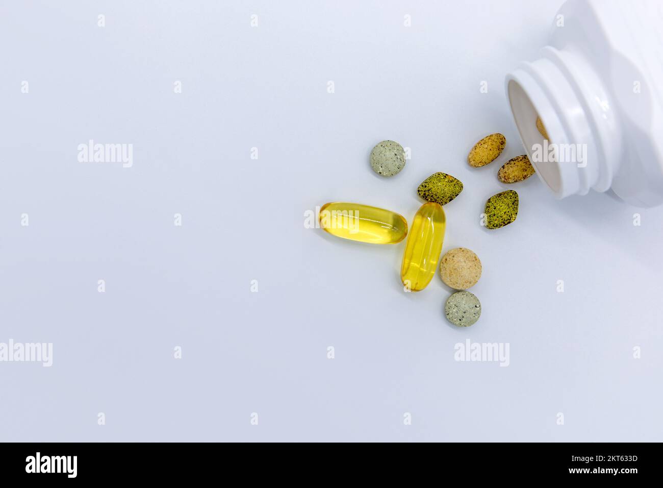 Nutritional supplements in white bottle packaging with dispersed pills Stock Photo - Alamy
