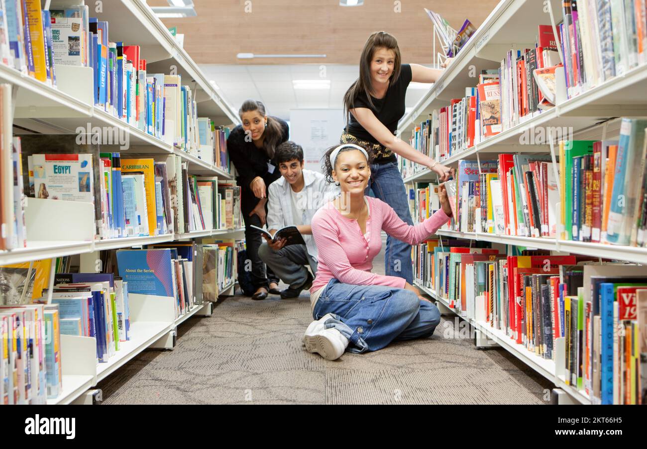 College Library: Book Worms. Bright smiles from a group of late teenage ...