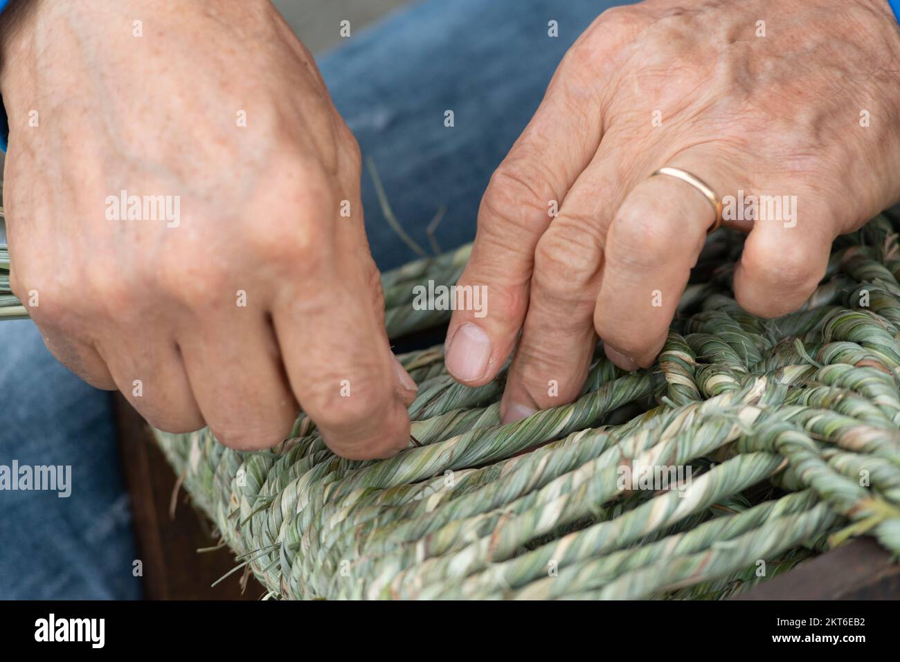 Italy, Lombardy, Chair-Mender bottoming a Chair With a Straw Stock ...