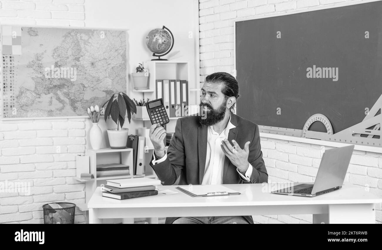 Countless Experience. male student calculating in school classroom ...