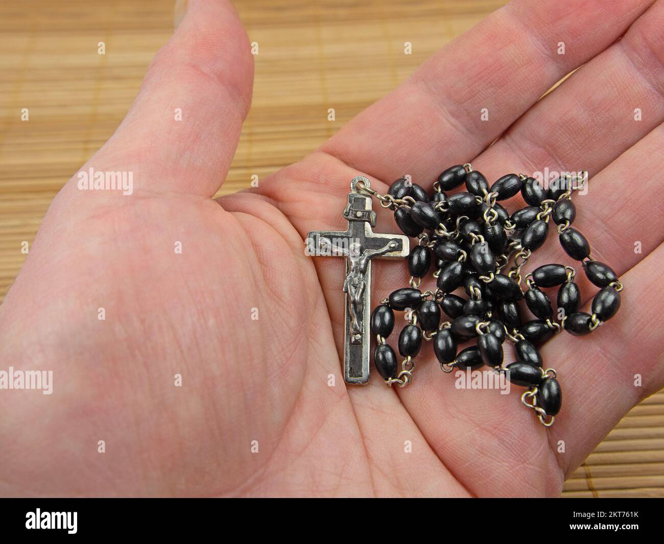 A rosary in hand Stock Photo - Alamy