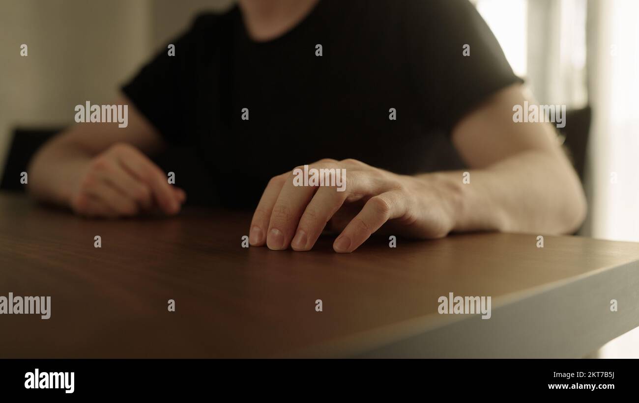 Man finger tap on walnut wood table indoor, shallow focus Stock Photo ...