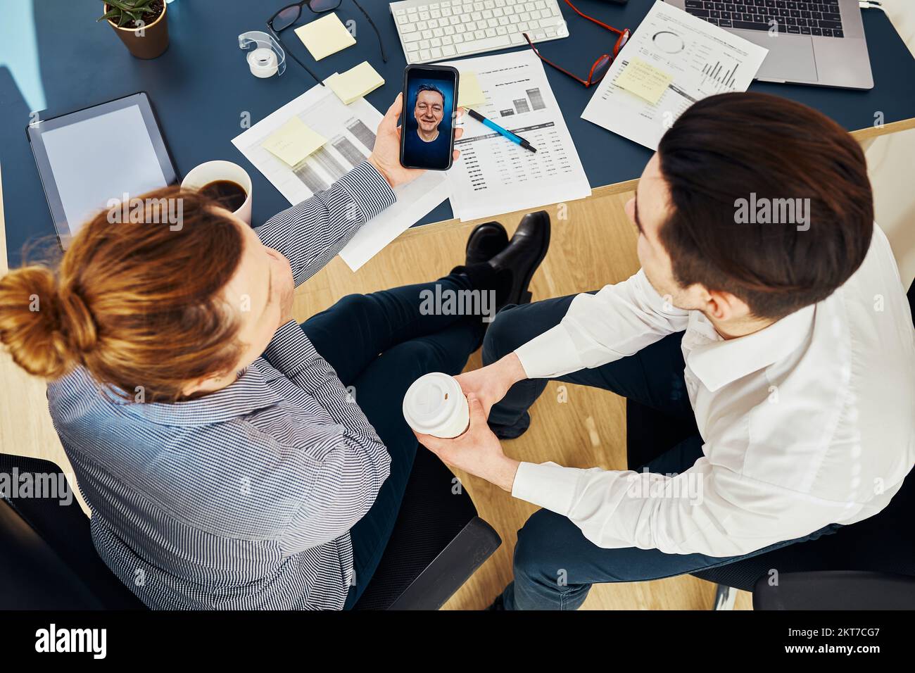 Business colleagues having video call discussing financial data working ...
