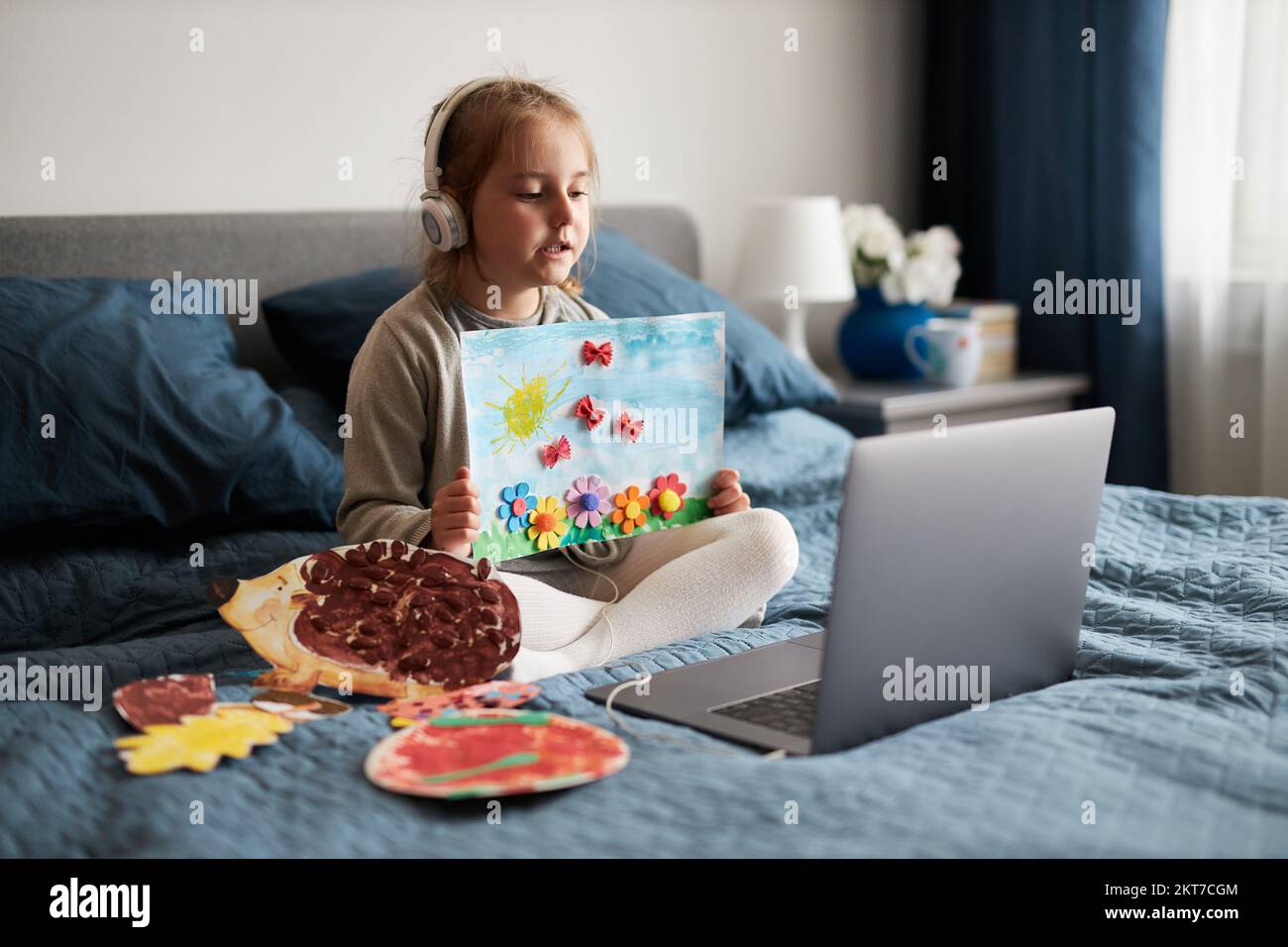 Little girl preschooler learning online showing her works drawings done ...