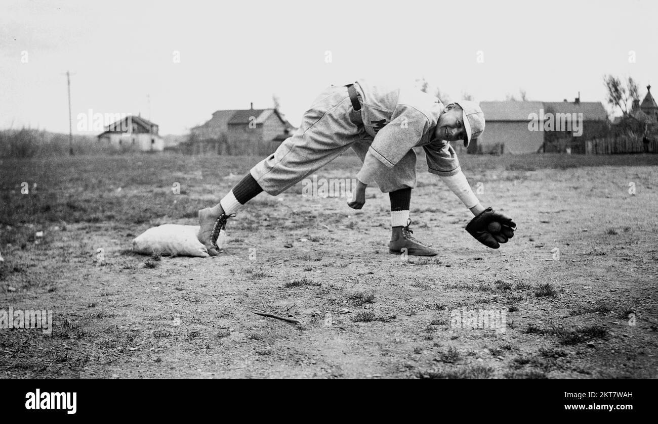 1934, historical, outside in a dirt field, a schoolboy in baseball gear ...
