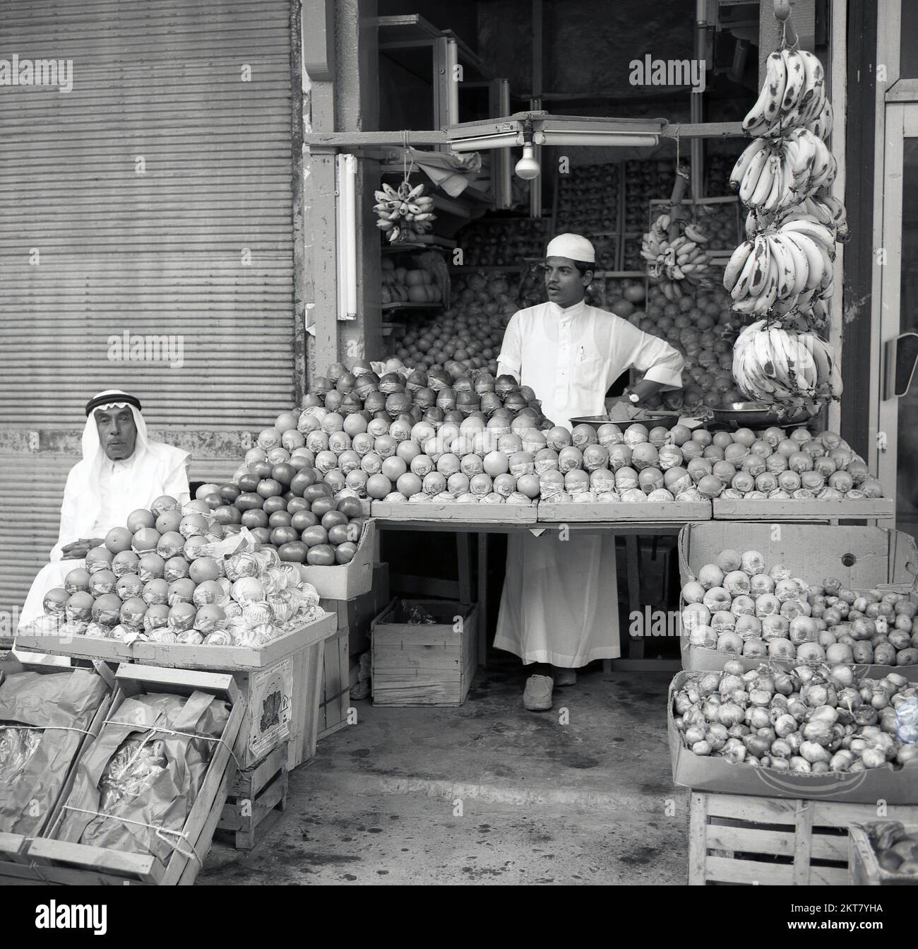 1960s, historical, a young male Saudi street seller, standing outside ...