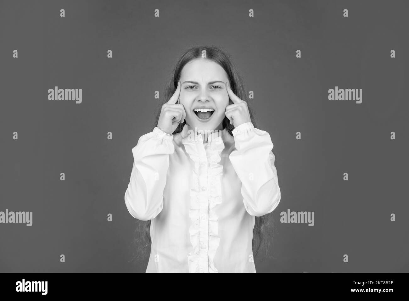 pondering teen girl in white shirt concentrating trying to make a ...