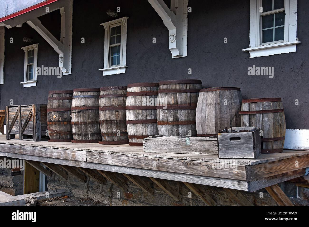 A row of old wooden barrels on a loading dock Stock Photo - Alamy