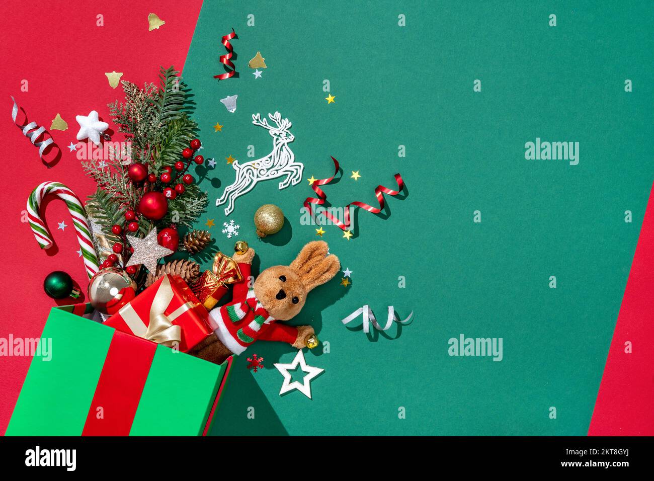 Holiday explosion from gift box on green background. Merry Christmas ...