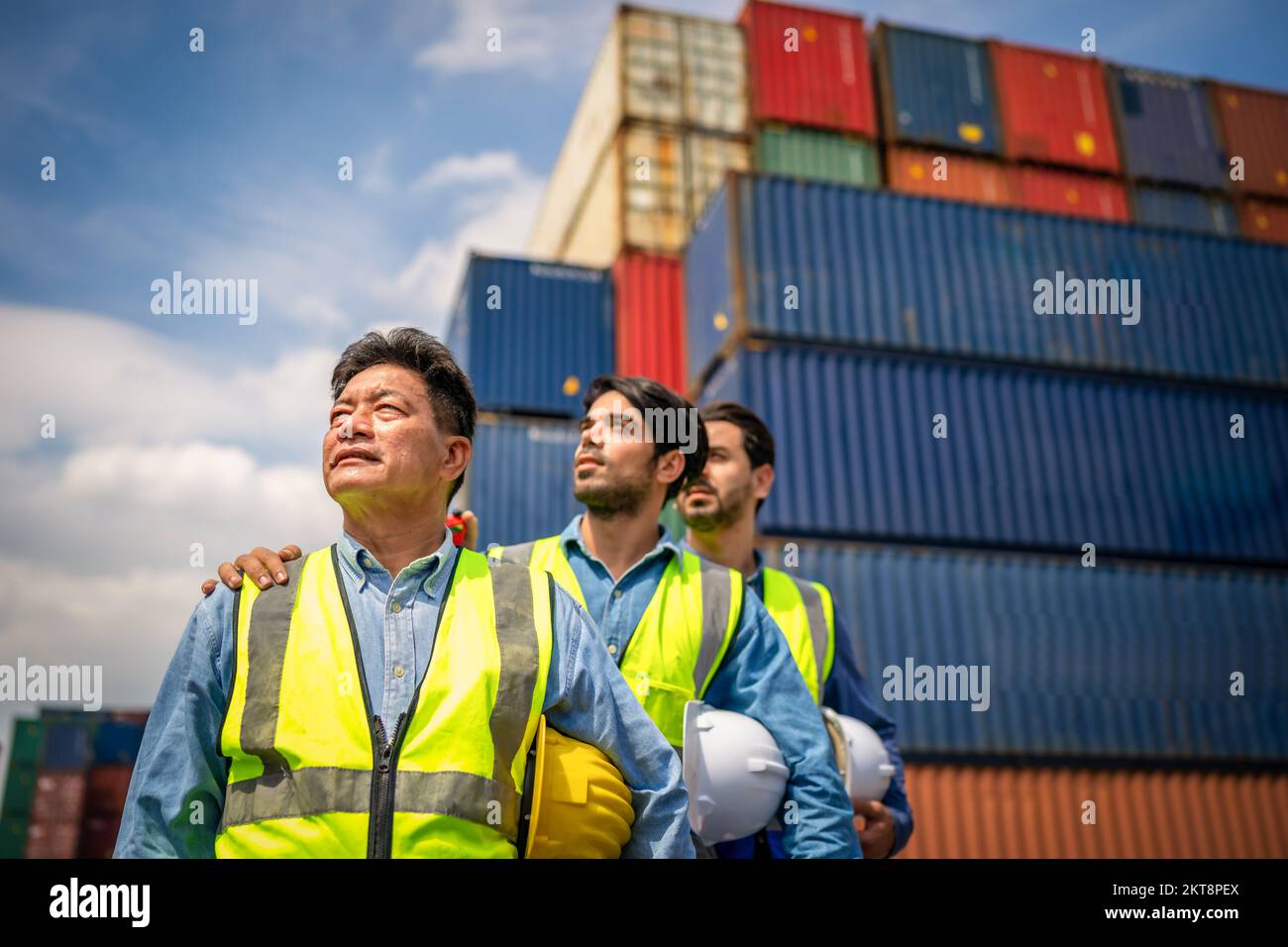 Portrait of Engineer or foreman team pointing up the future with cargo ...