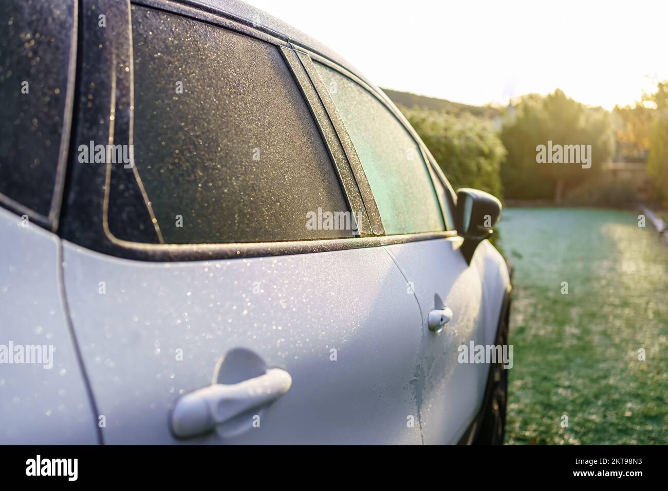 White car covered with ice at dawn due to the intense cold of winter ...