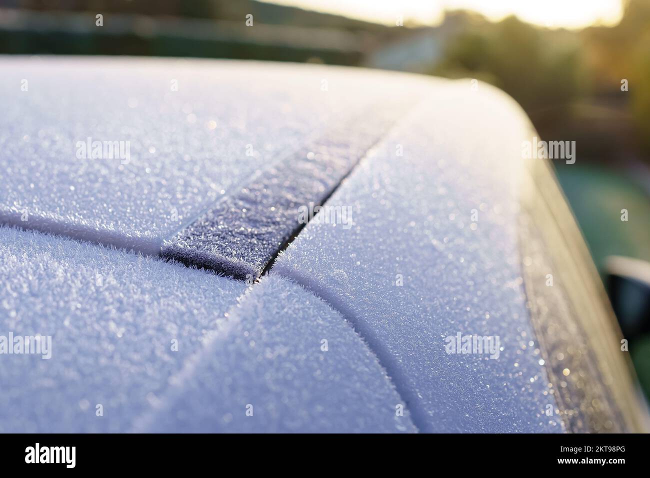 White car covered with ice at dawn due to the intense cold of winter ...