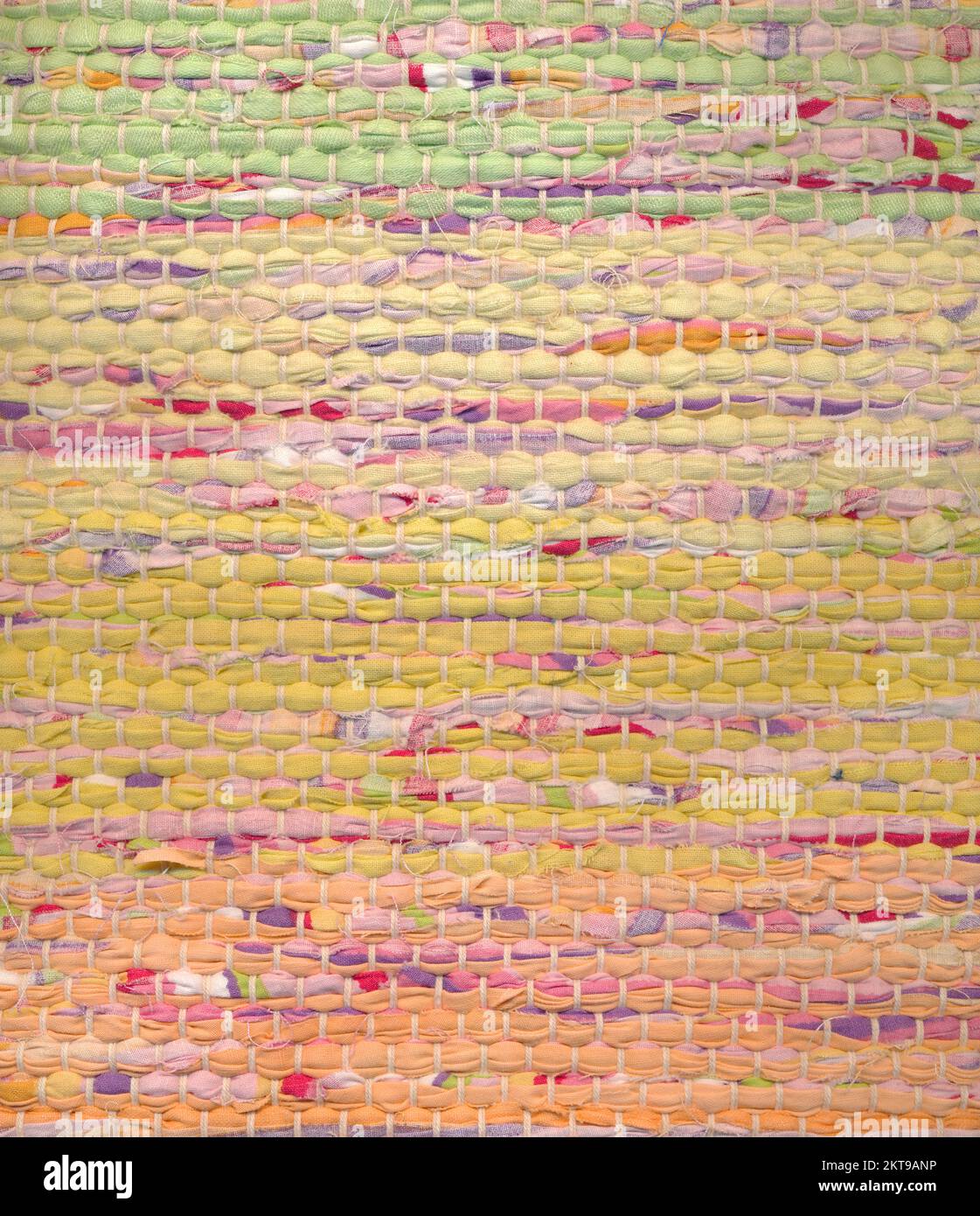 Closeup of handwoven rug rug in warm and bright pastel colors, plain ...