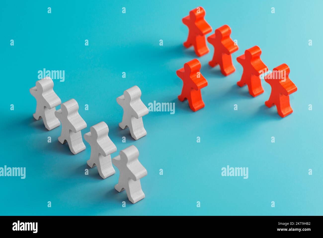 Two groups of wooden figures are standing in front of each other Stock ...