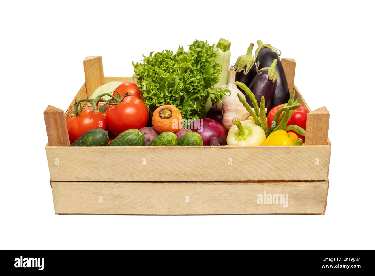 Fresh vegetables in a wooden box isolated on a white background. Eco ...