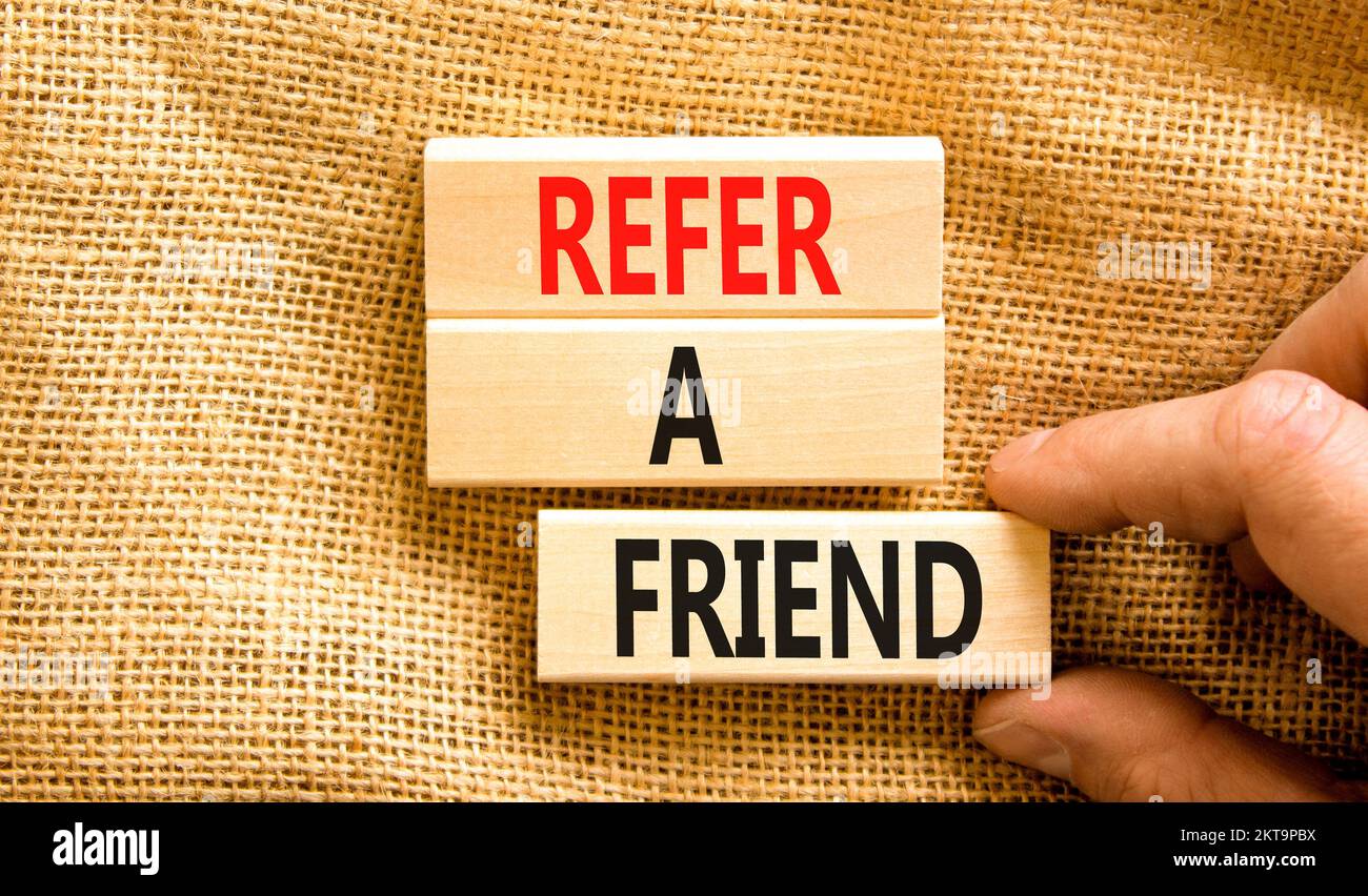Refer a friend symbol. Concept words Refer a friend on wooden blocks on ...