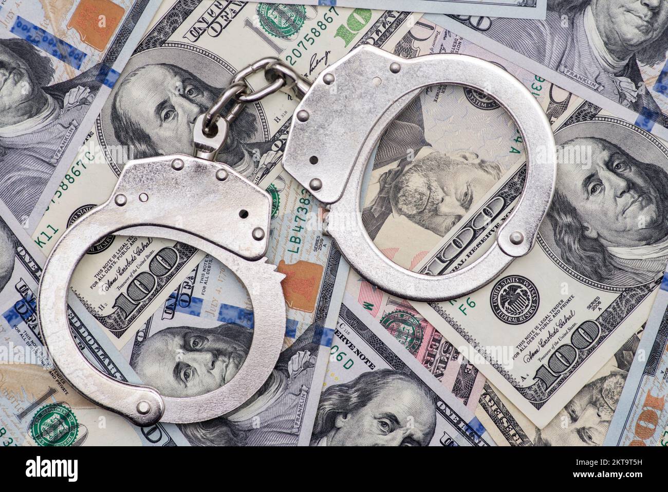 Handcuffs on money background. Dollar bills, money cash corruption ...