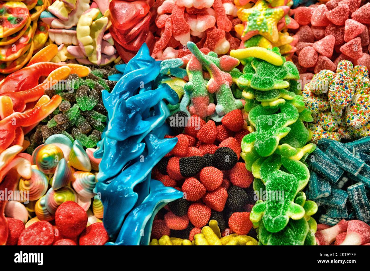 Selection of mixed colourful children's sweets on display for sale at a ...