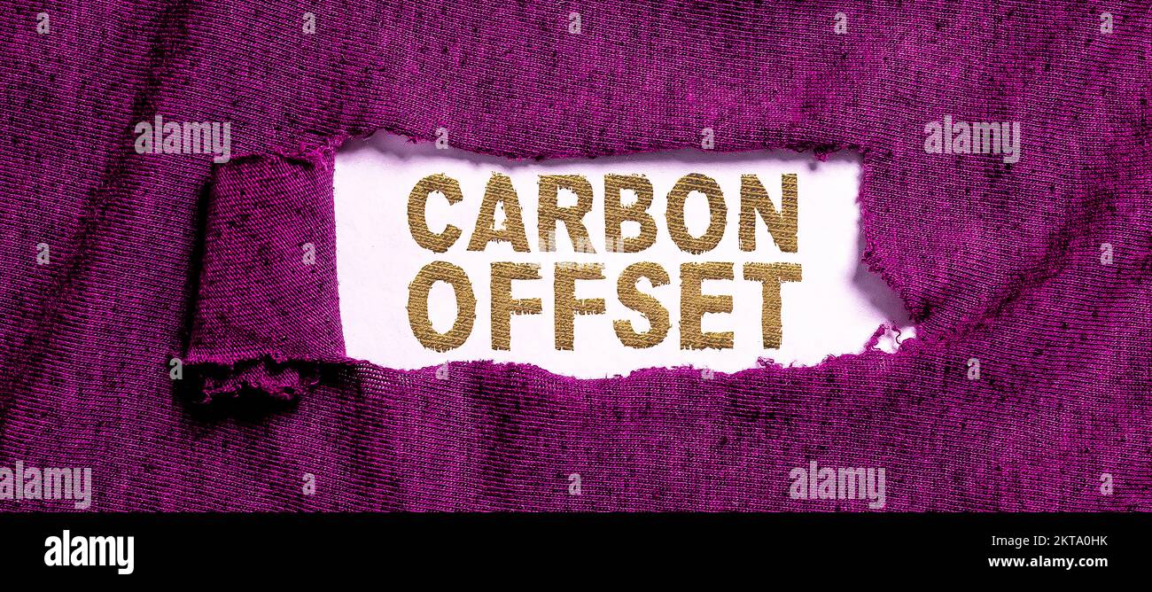 Sign displaying Carbon Offset, Word for Reduction in emissions of ...