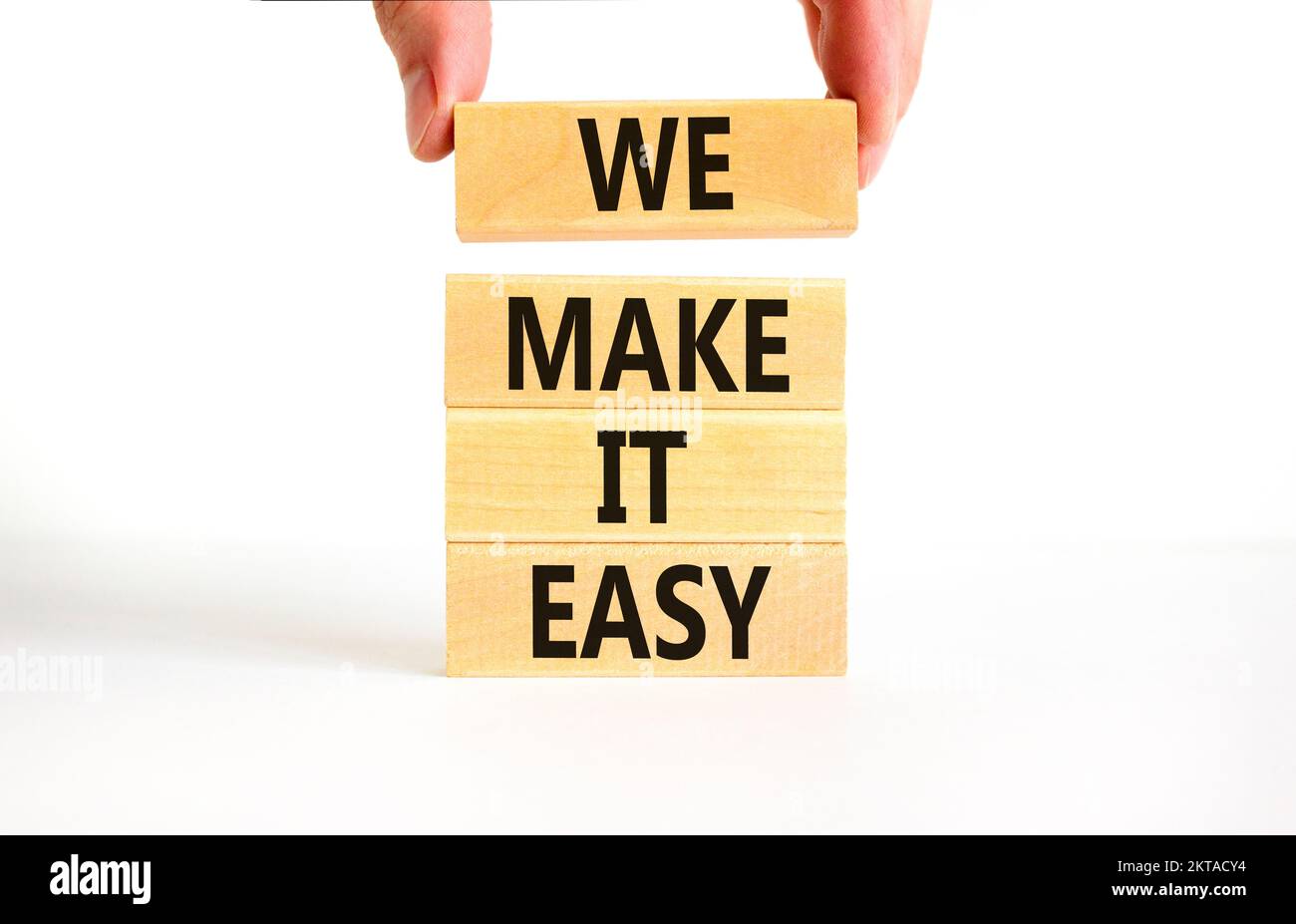 We make it easy symbol. Concept words We make it easy on wooden cubes ...