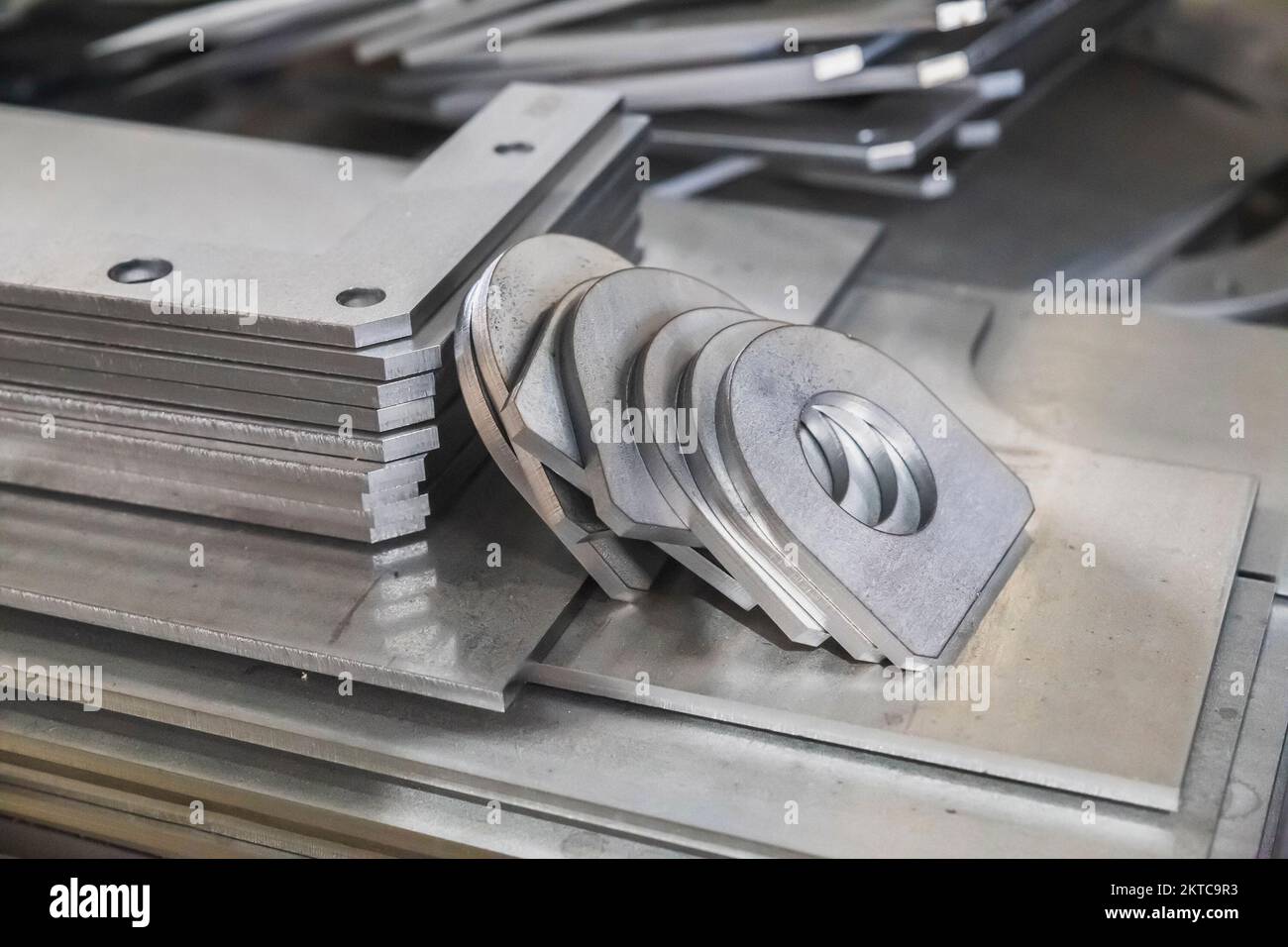 Laser cut iron parts in factory warehouse Stock Photo - Alamy