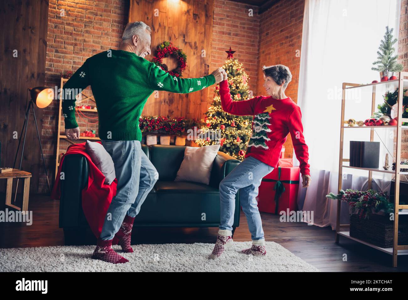 Full size portrait of two excited aged partners hold hands have fun ...