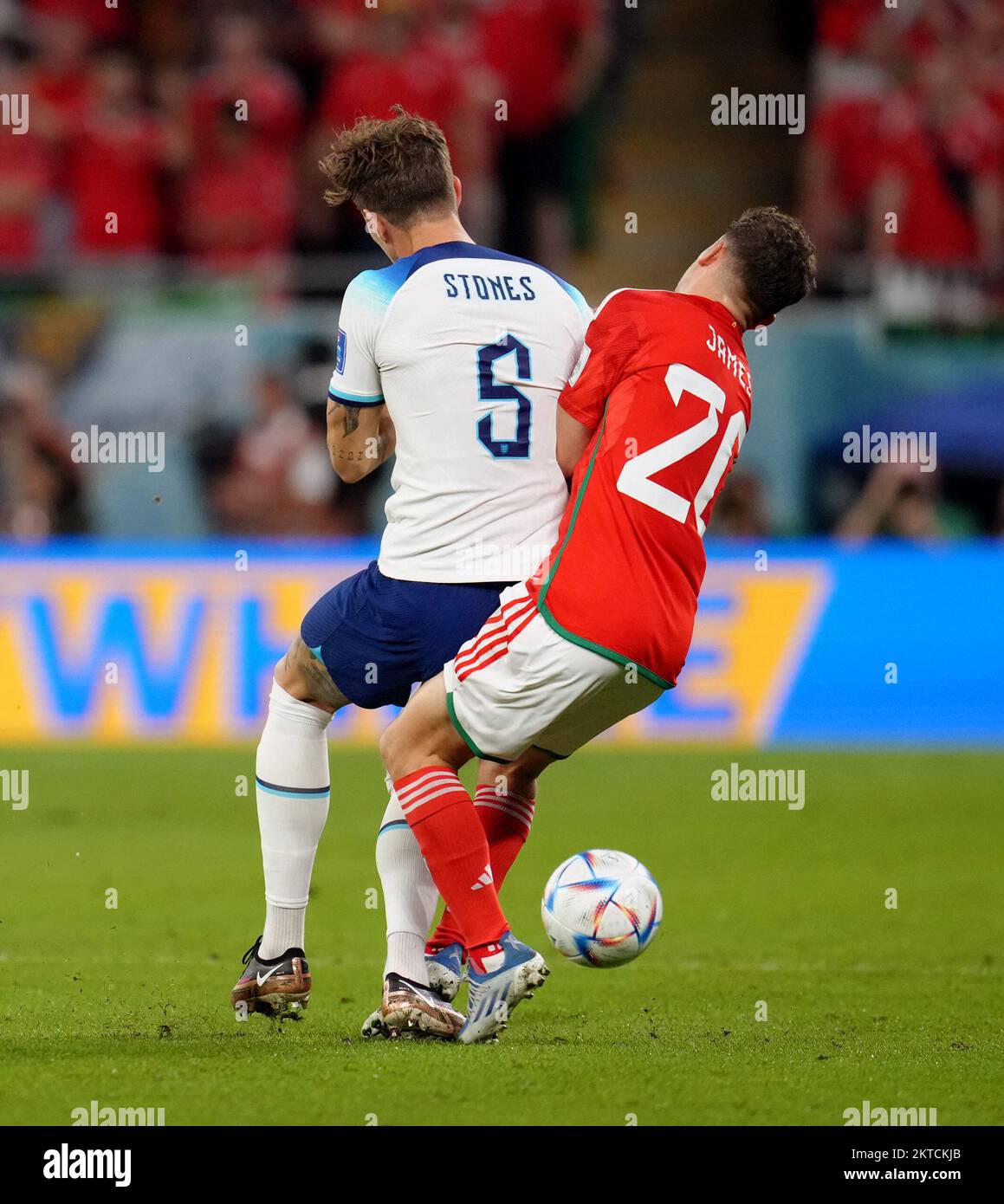 Wales' Daniel James challenges England's John Stones, resulting in a ...