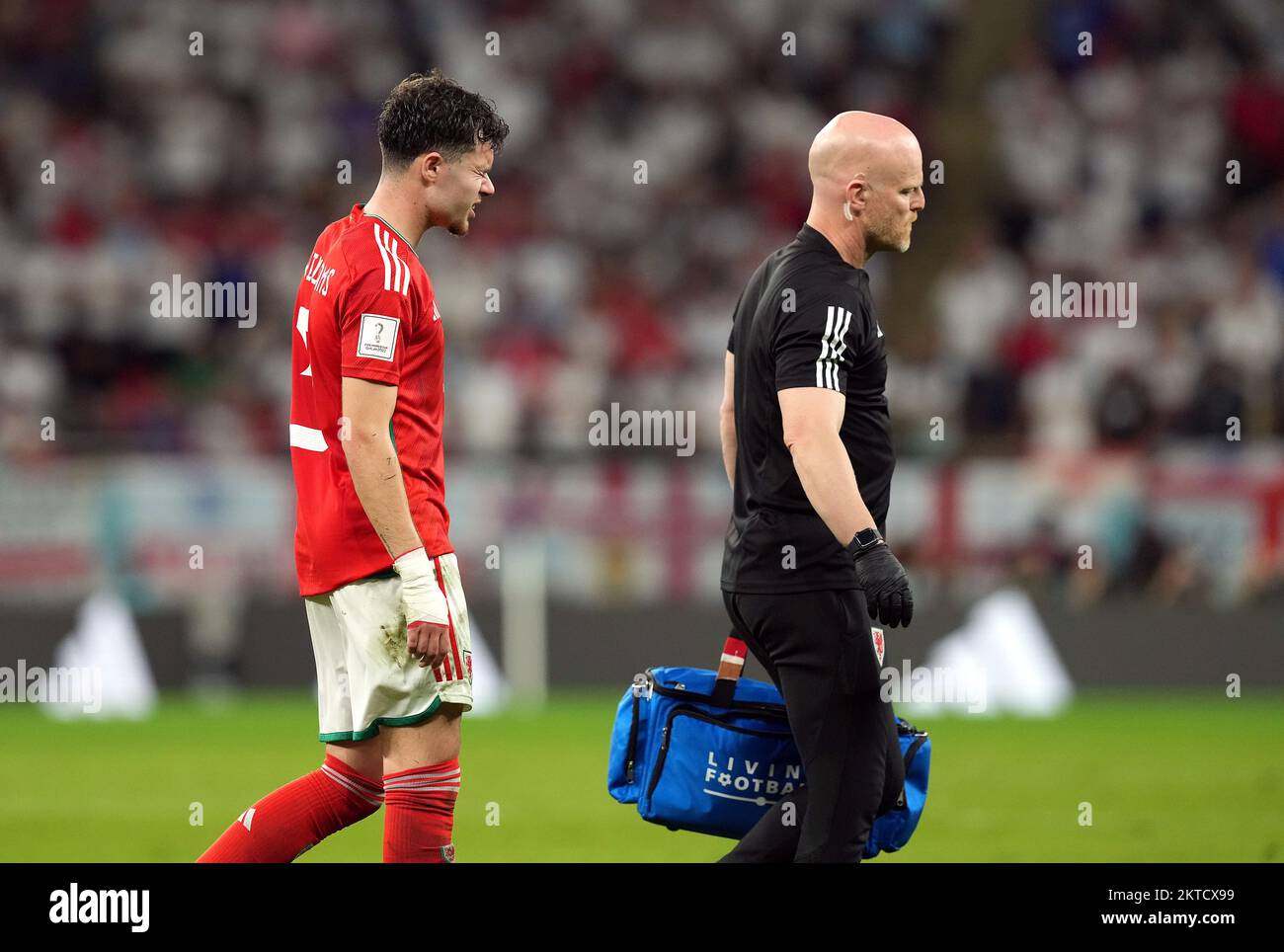 Wales’ Neco Williams leaves the pitch as a suspected concussion ...