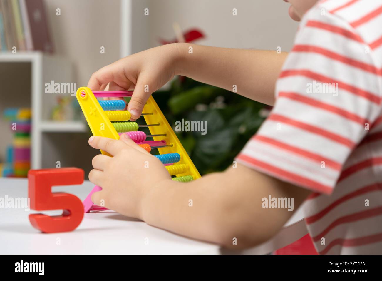 A small child learns to count on abacus, mathematics, arithmetic for ...