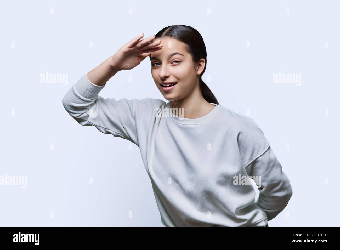 Teenage girl looking at camera with hand on her forehead Stock Photo ...