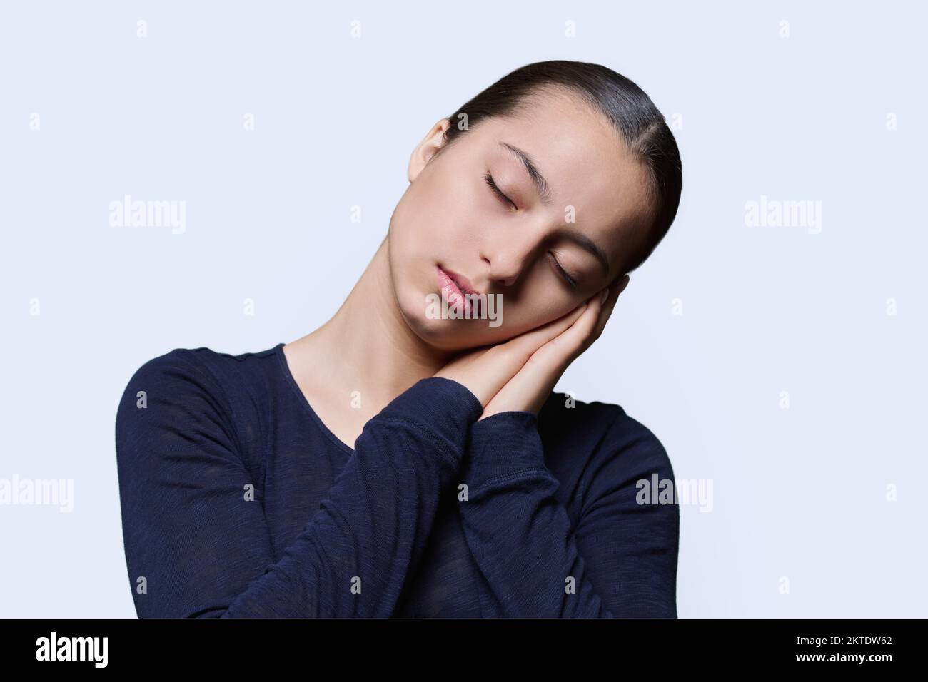 Young woman sleeping with closed eyes, on white studio background Stock ...