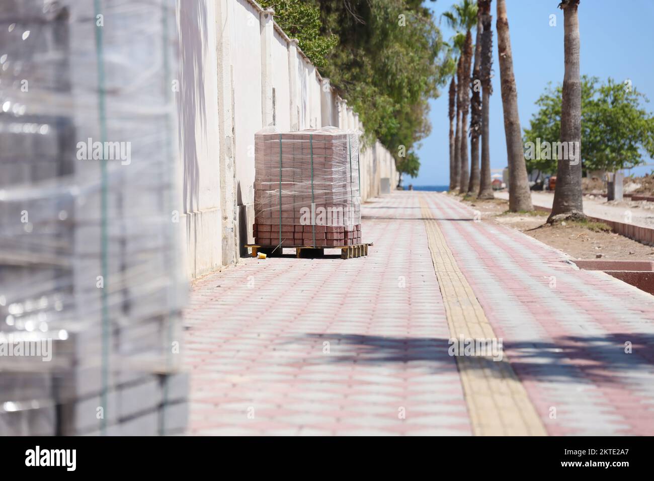 Paving stones on wooden pallet on the street sidewalk. Construction ...