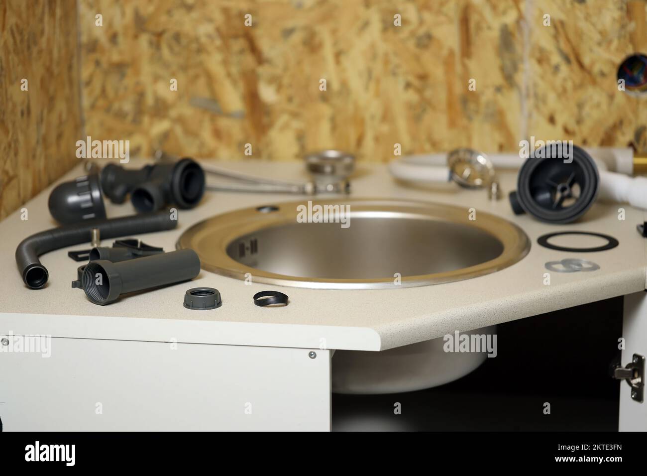 Plumbers tools and water tap ready for installation near sink on ...