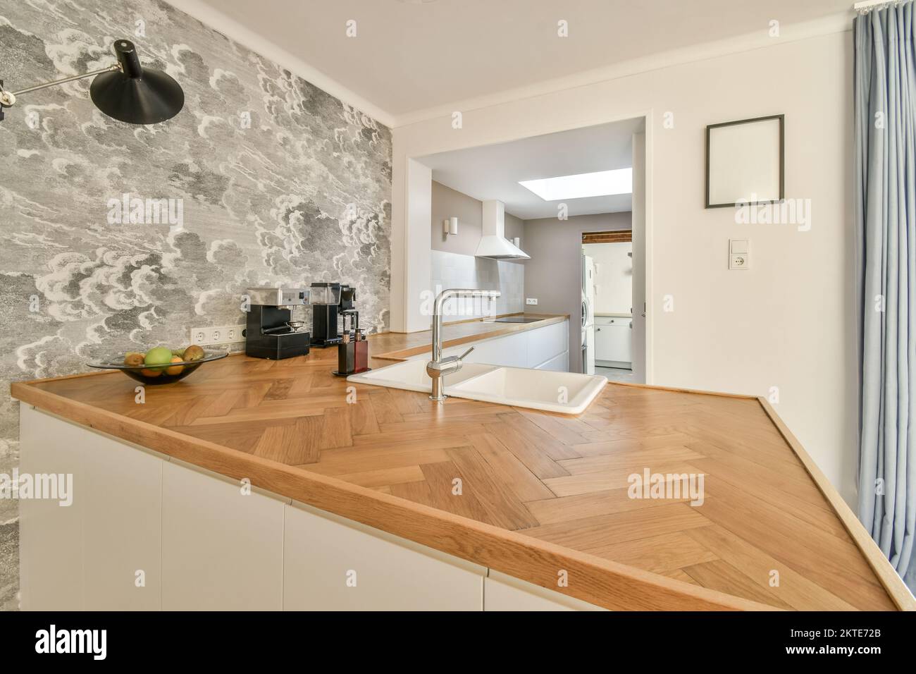 Table with chairs and flowers located near lounge area and kitchen in ...