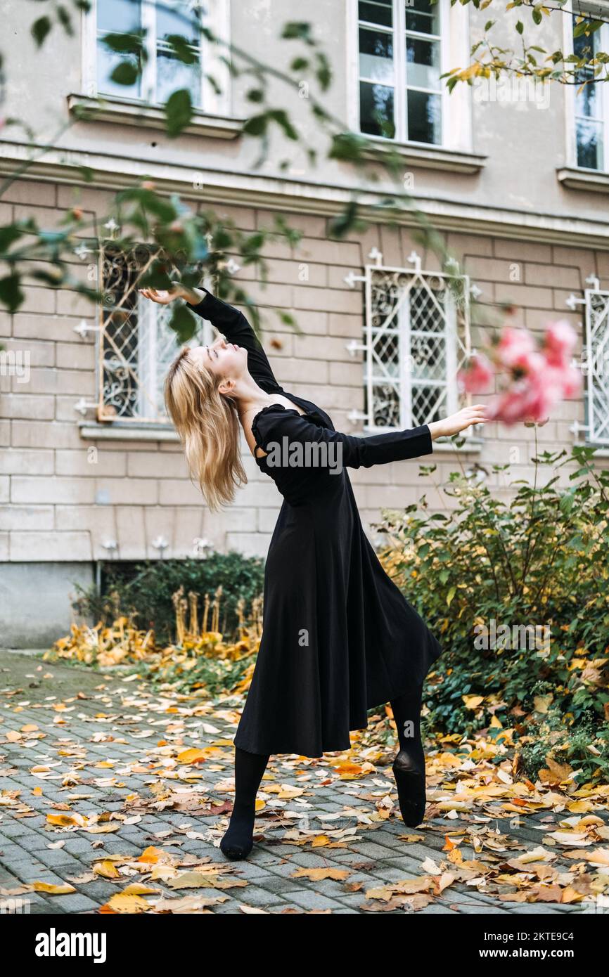 Ballerina Dancing in autumn city street, Modern Ballet Dancer in black ...
