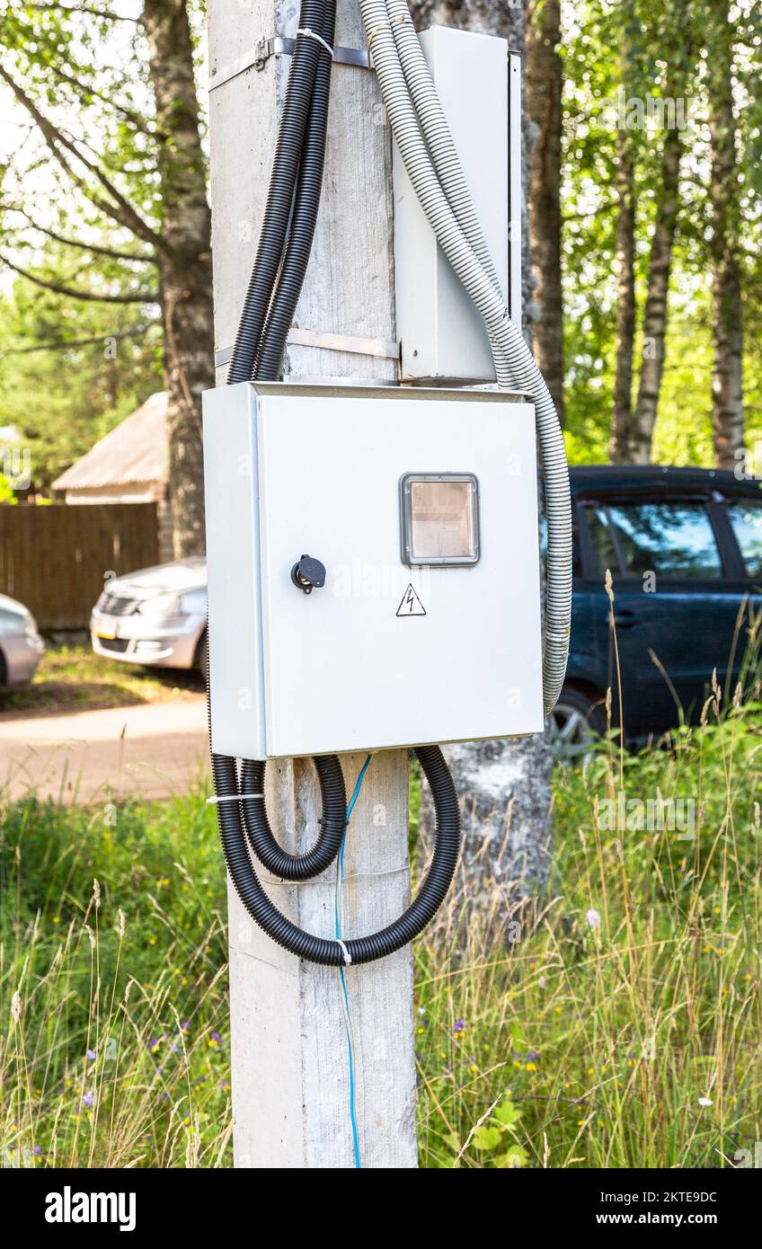 Electrical distribution board on a power line support in summer ...