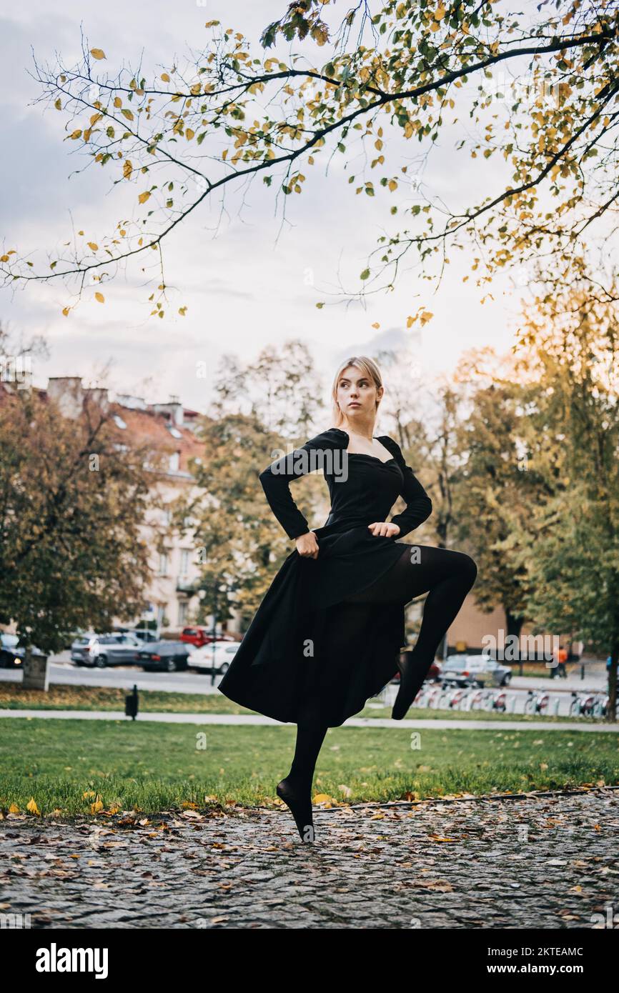 Ballerina Dancing in autumn city street, Modern Ballet Dancer in black ...