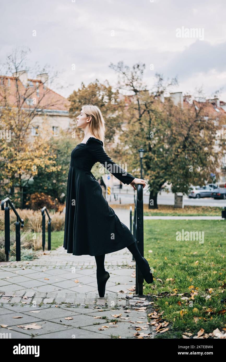 Ballerina Dancing in autumn city street, Modern Ballet Dancer in black ...