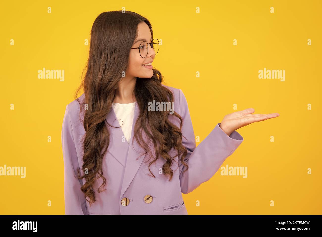 Impressed teenage girl showing recommendation copyspace. Child teenager ...
