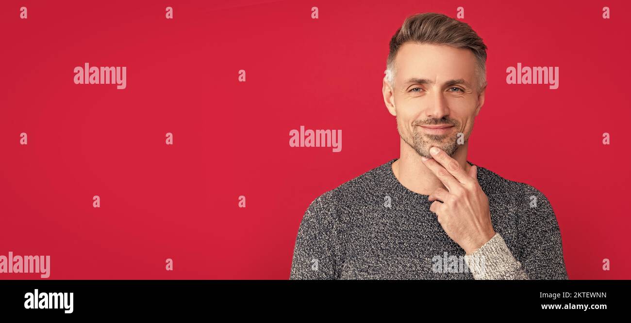 smiling handsome man wear sweater on red background, portrait. Man face ...