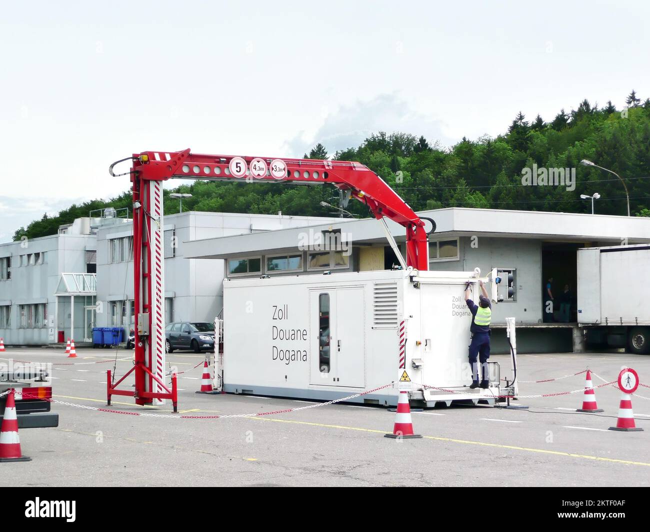 A customs house officer is setting up the x ray check device at a ...