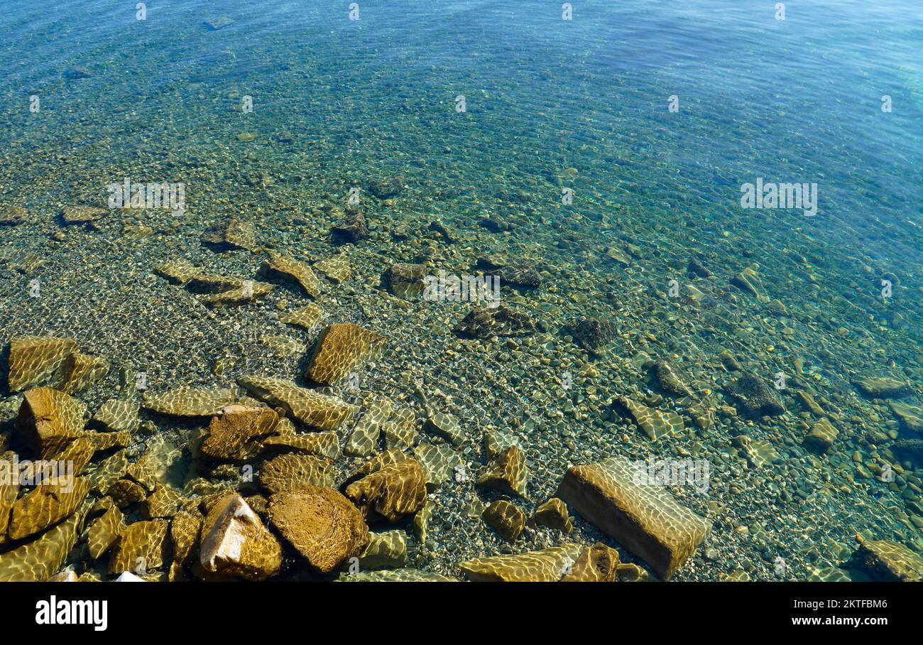 clear turquoise waters of lake Constance or Bodensee with stones ...