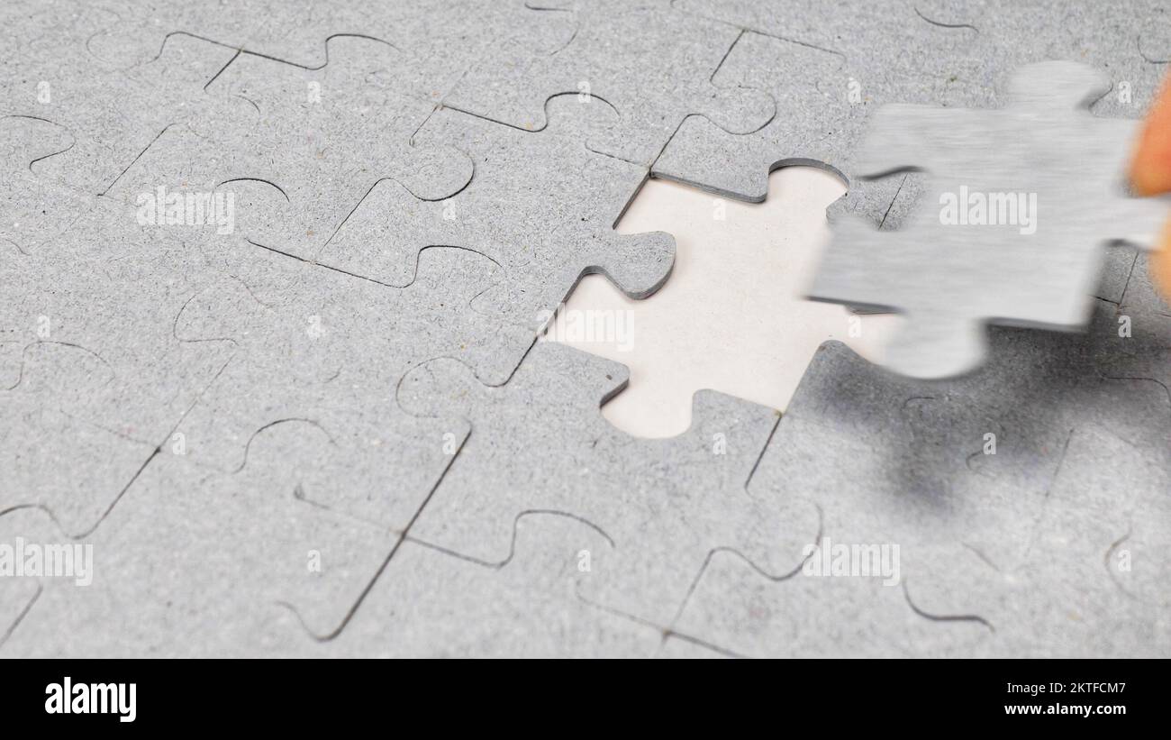 put the last piece of jigsaw puzzle to complete the mission on white ...