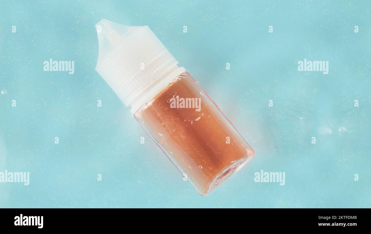 Cosmetic jar . Against the background and glass of water. Blue colour ...