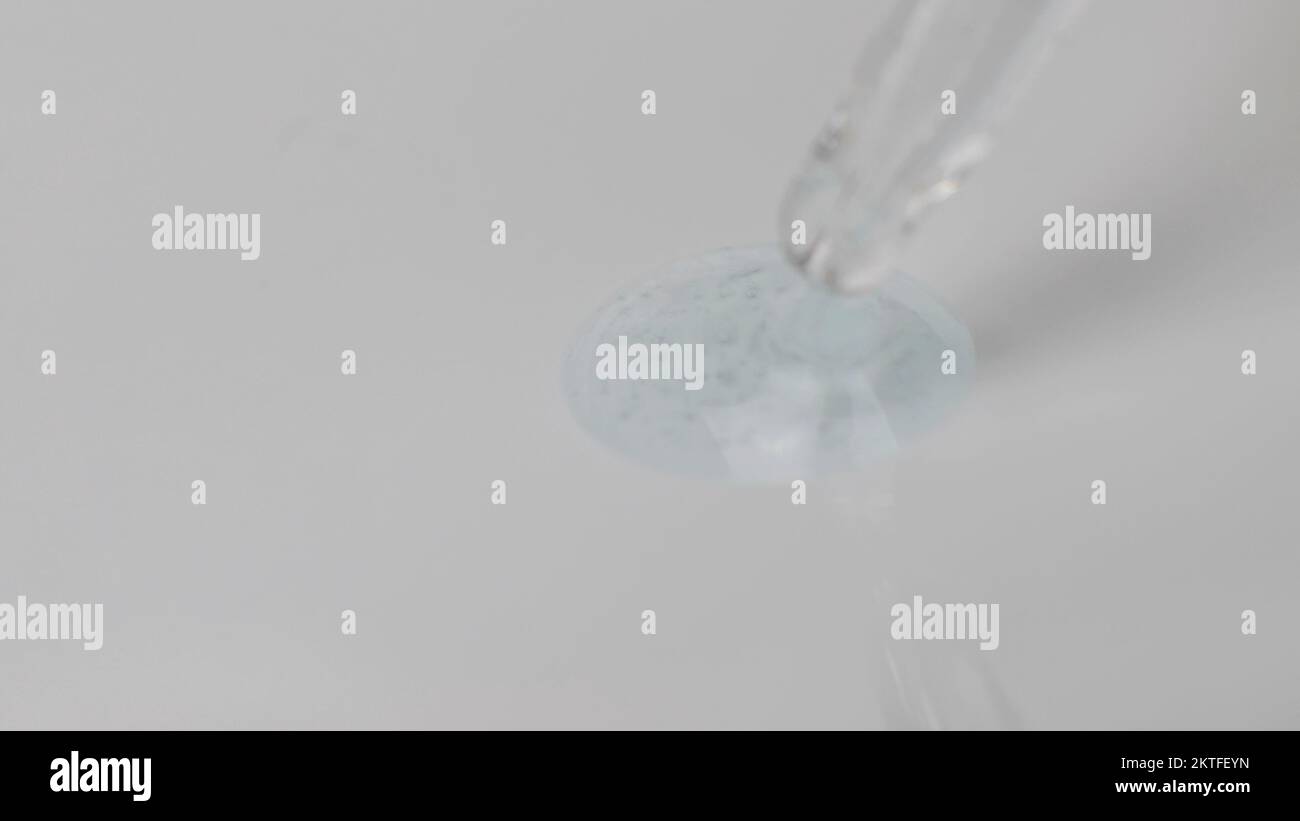 Grayscale macro shot of gel with tiny bubbles of various sizes flowing ...