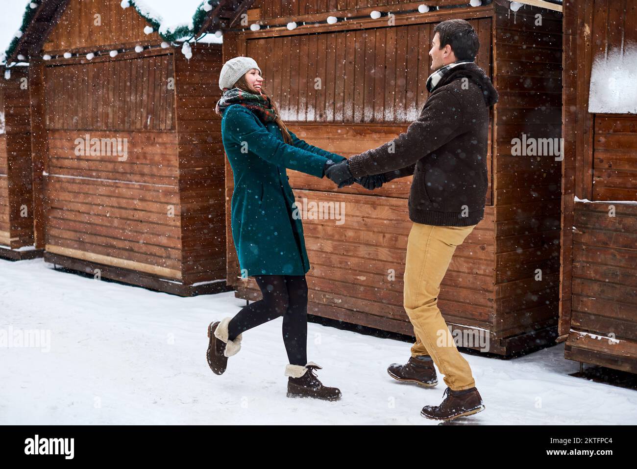 happy couple in love have fun in festive Christmas fair in city center ...