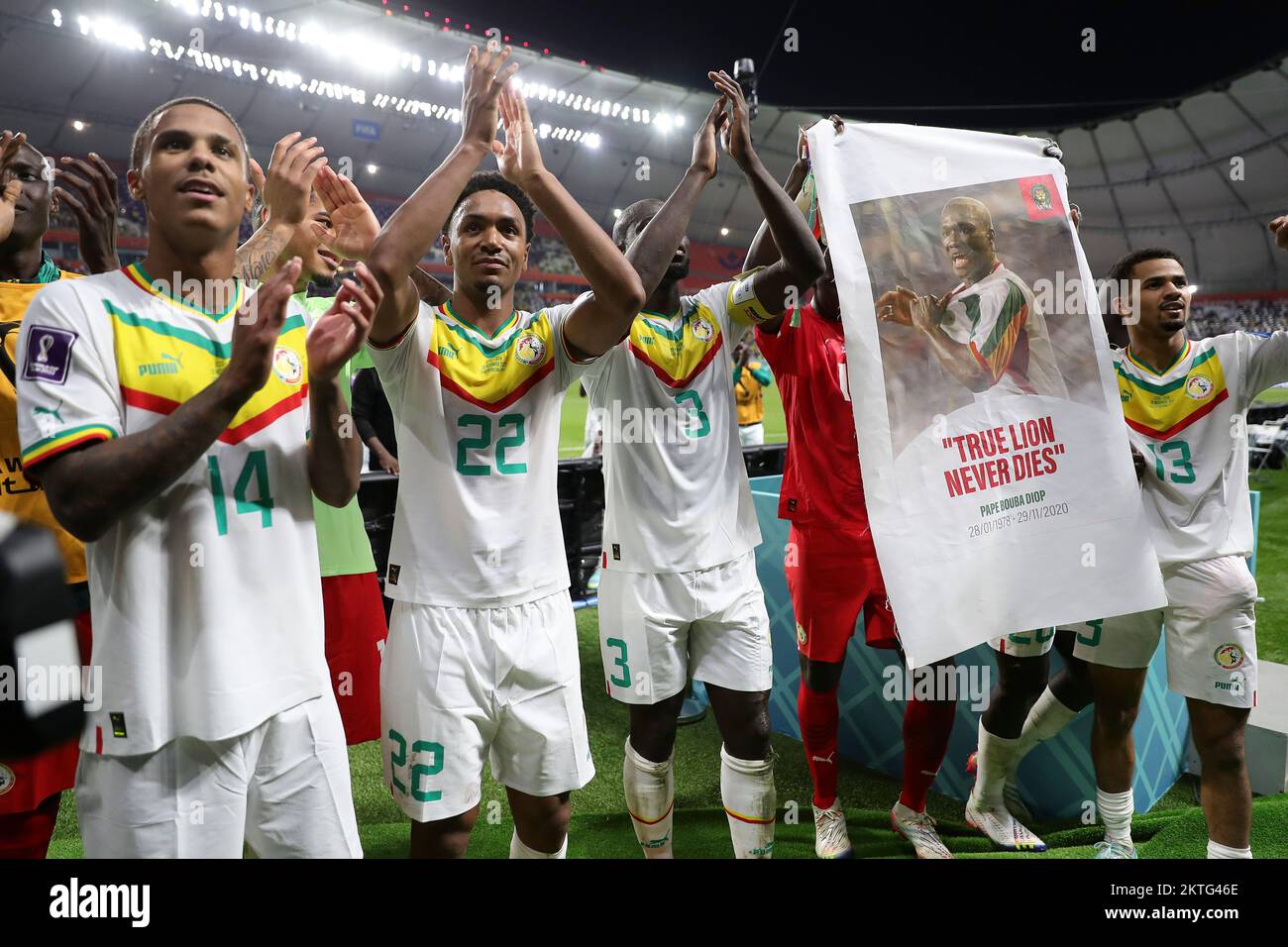 Doha, Qatar. 29th Nov, 2022. Senegal players hold up a banner in memory ...