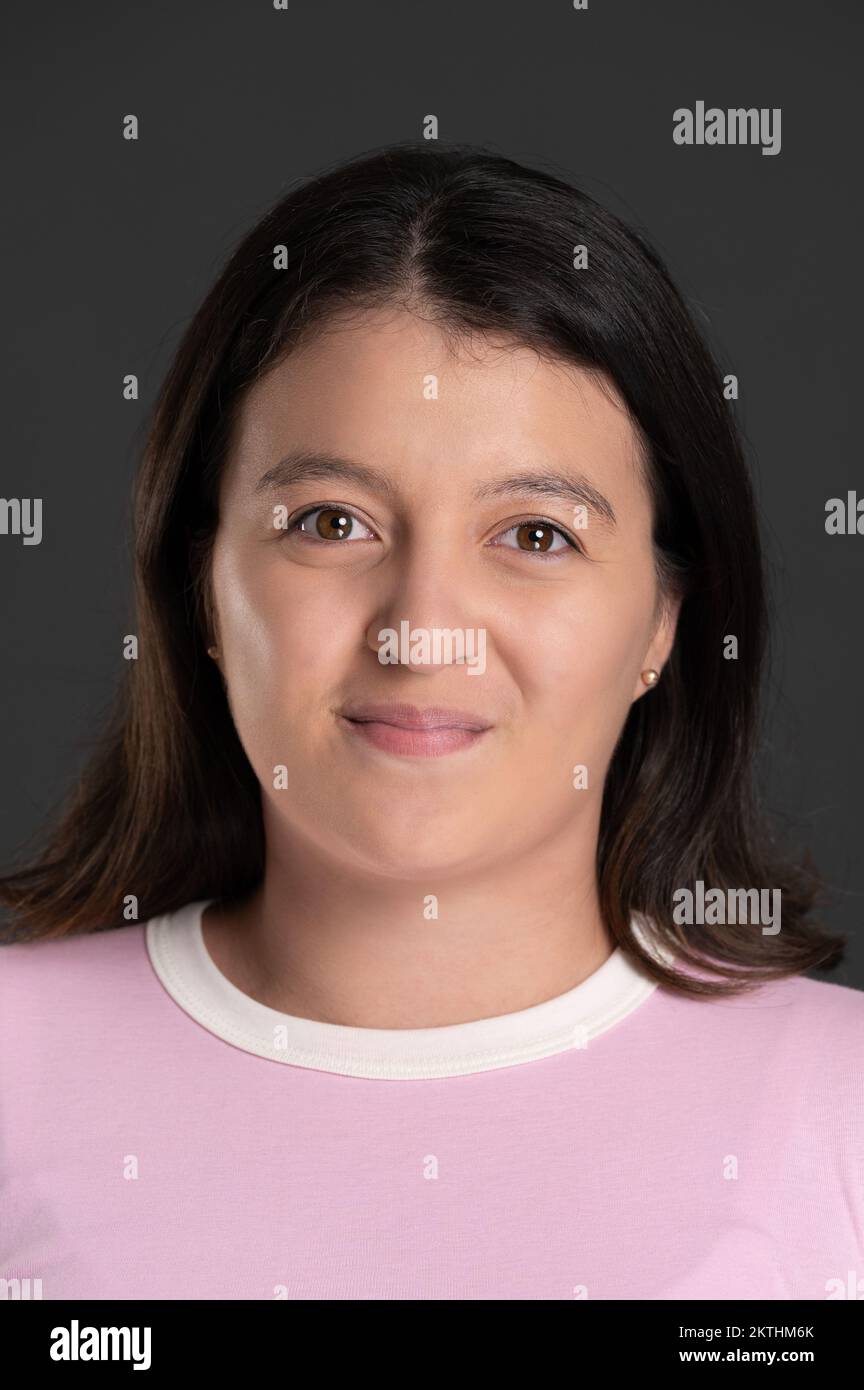 Portrait of young hispanic woman close up view on studio background ...