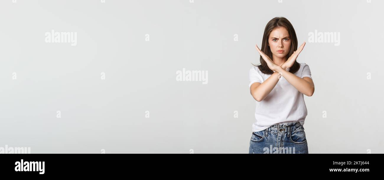 Serious angry woman showing cross, stop something bad, express ...